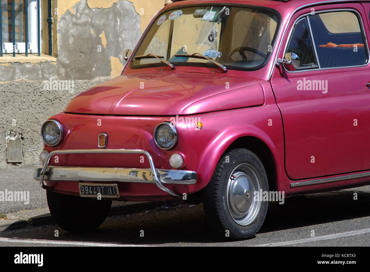 Pink purple Fiat 500 parked on the street. Classic vintage model ...