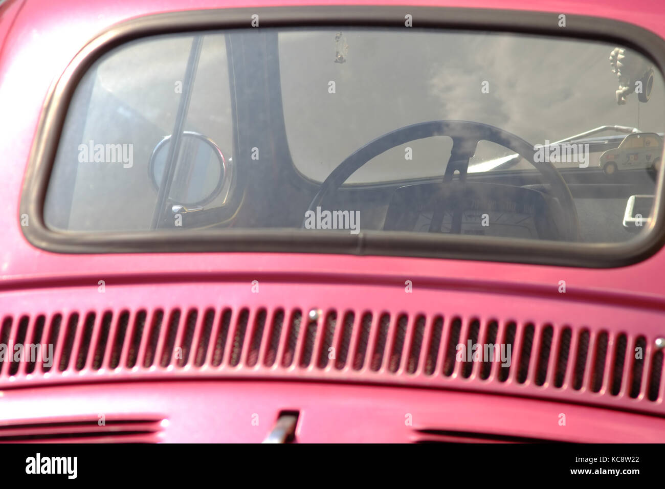 Pink purple Fiat 500 parked on the street. Classic vintage model ...