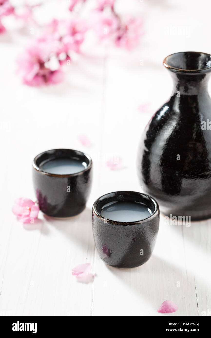 Unfiltered white sake sake with flowers of blooming cherry Stock Photo ...