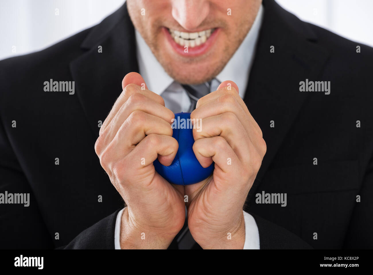 Close-up Of Businessman Pressing Stress Ball In Office Stock Photo - Alamy