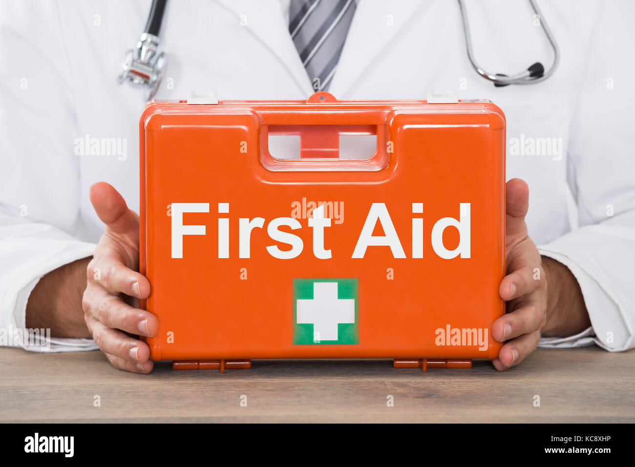 Close-up Of Young Male Doctor Hand Holding First Aid Kit Box In Clinic ...