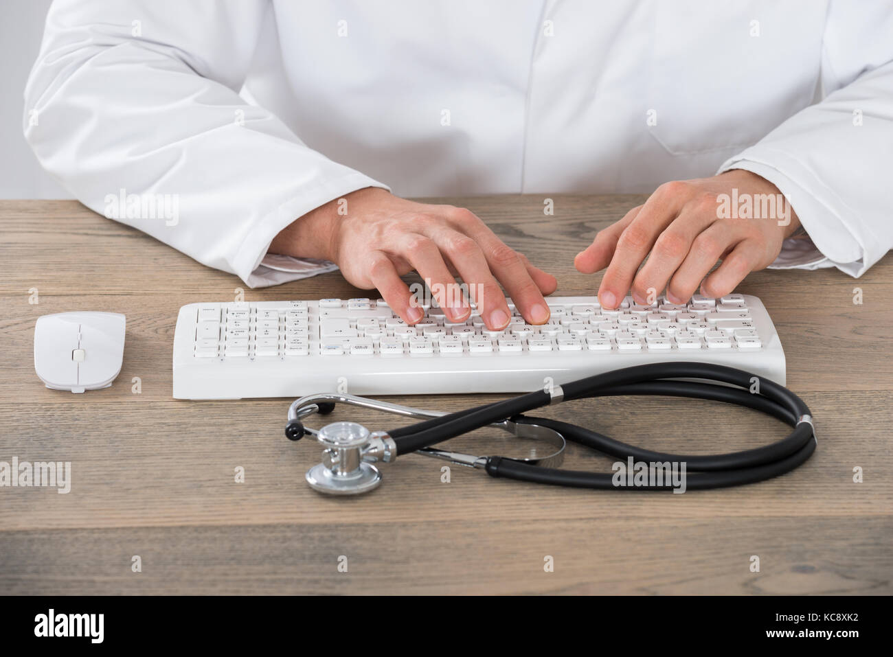 Doctor typing computer hi-res stock photography and images - Alamy