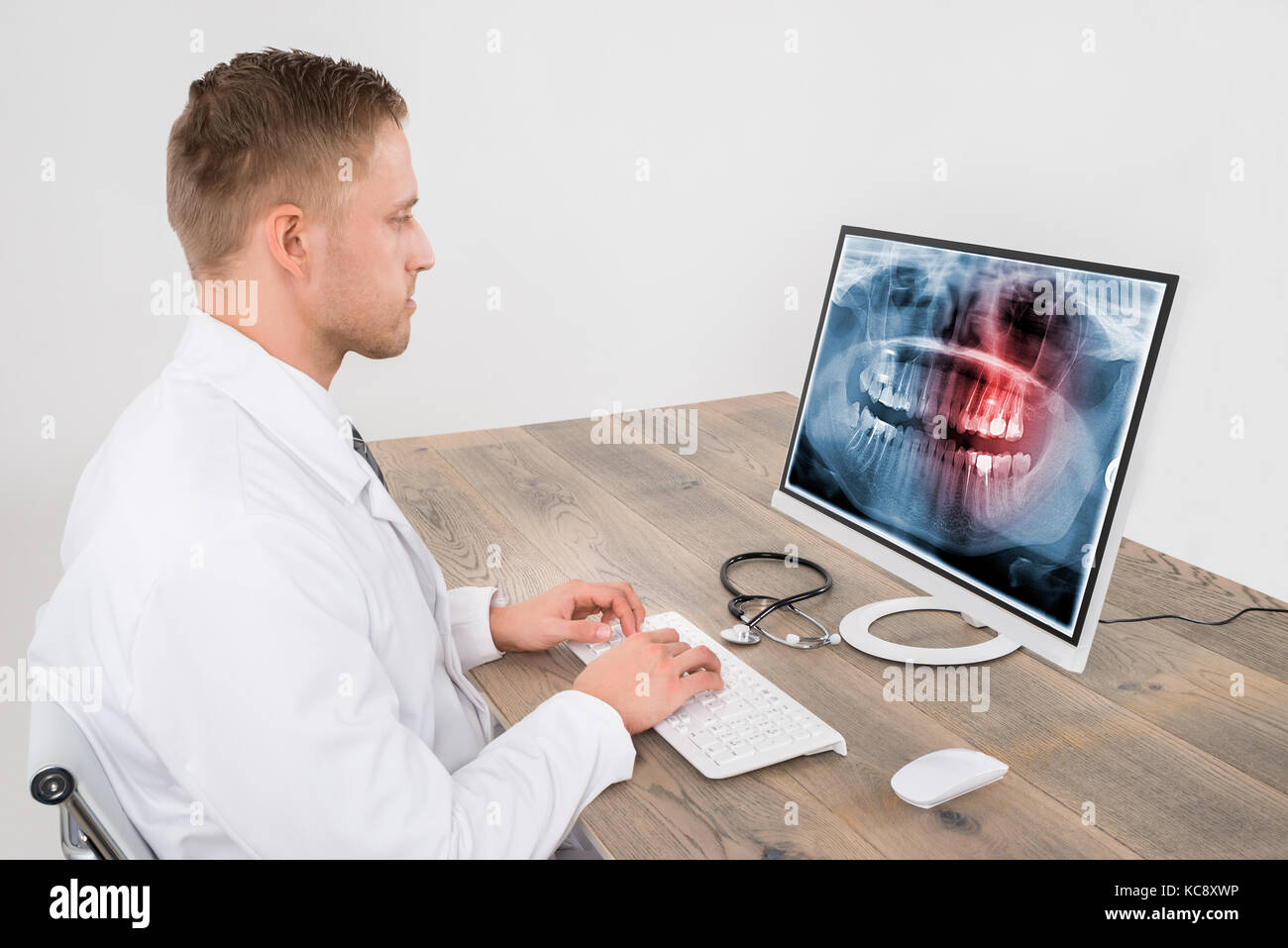 Doctor Looking At Teeth X-ray On Computer In Hospital Stock Photo - Alamy
