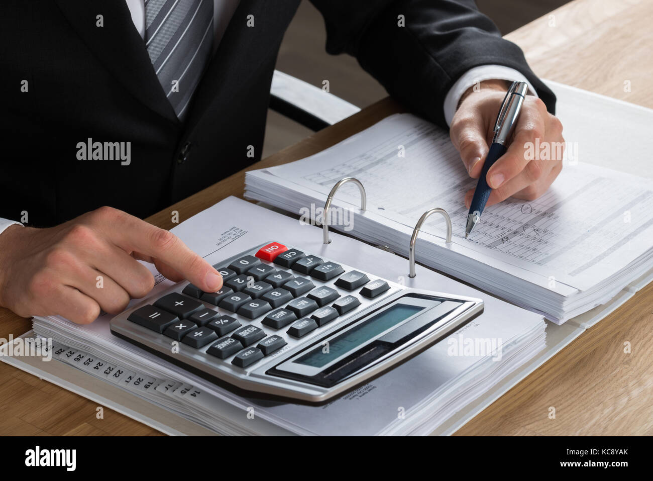 Close-up Of Male Accountant Calculating Tax At Desk In Office Stock ...
