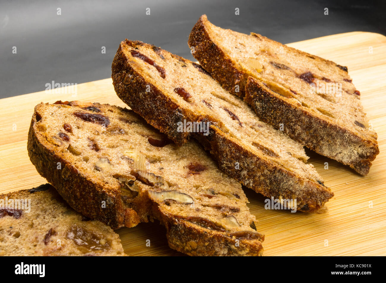 Slices of malt bread handmade with nuts, raisins and cranberries on ...