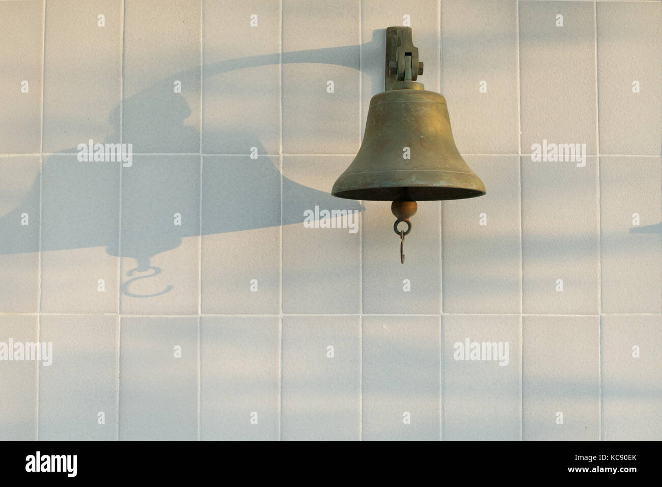 Bell on a tiled wall Stock Photo - Alamy