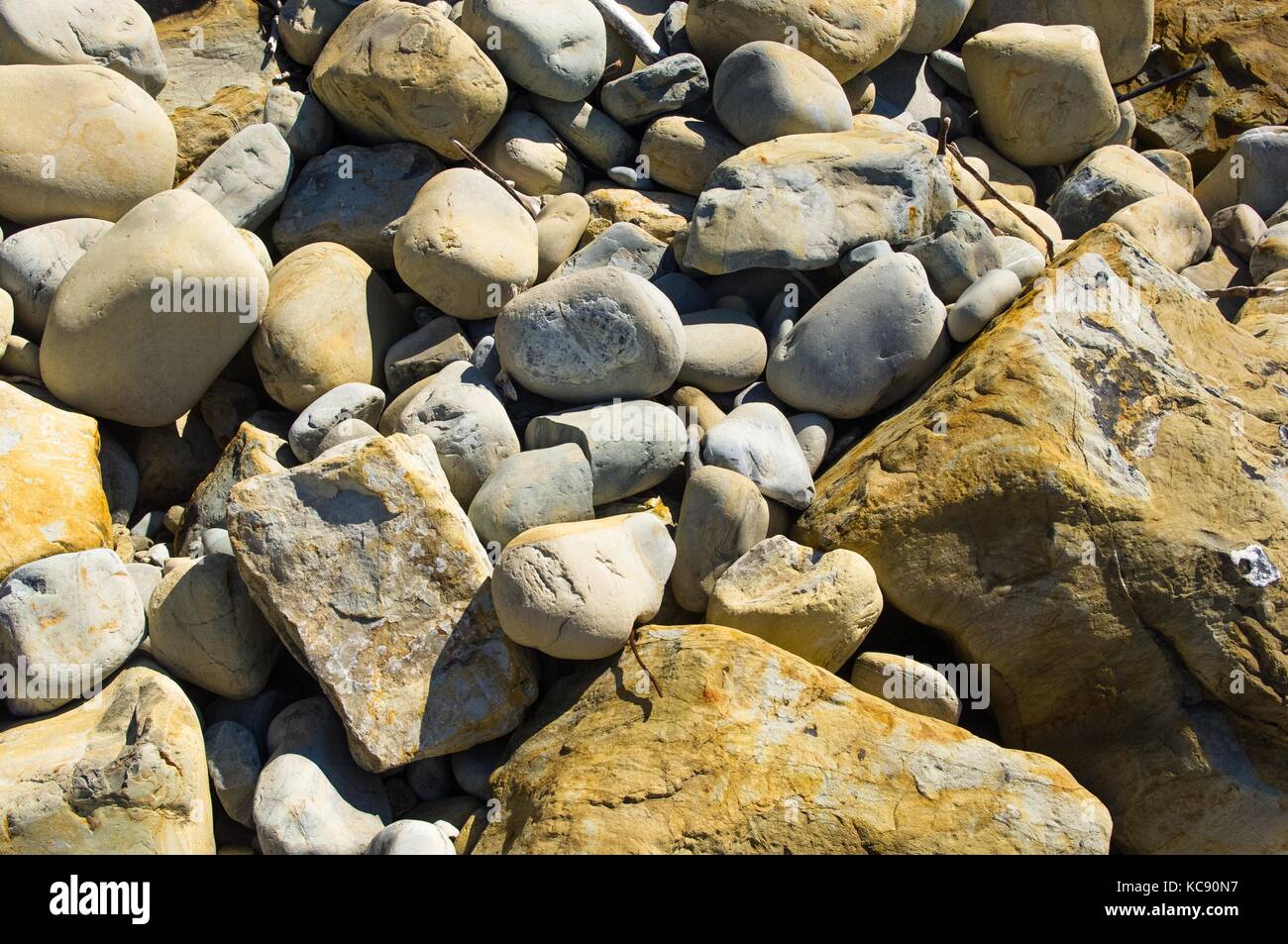 boulders and colorful pebbles on the beach on a warm summer day Stock ...