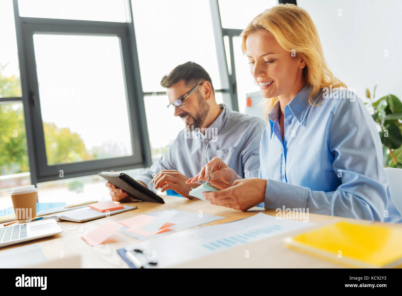 Positive delighted colleagues enjoying their task Stock Photo - Alamy