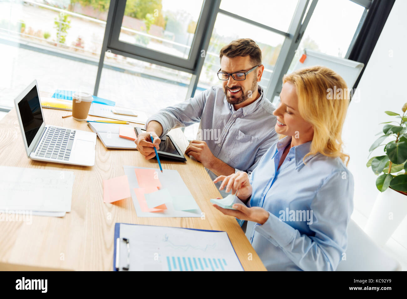 Smiling man pointing at project work Stock Photo - Alamy