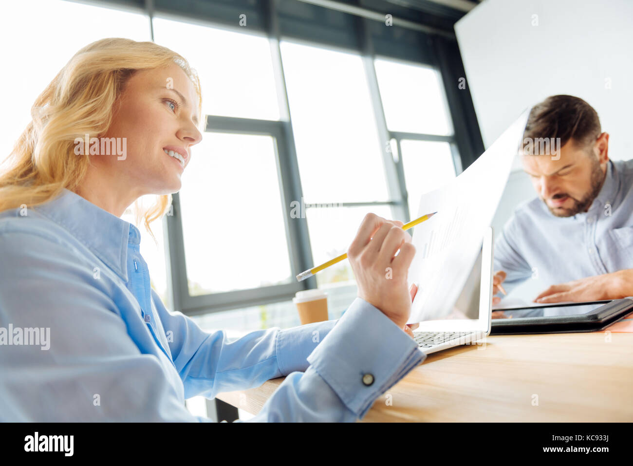 Low angle photo of positive woman while reading Stock Photo - Alamy