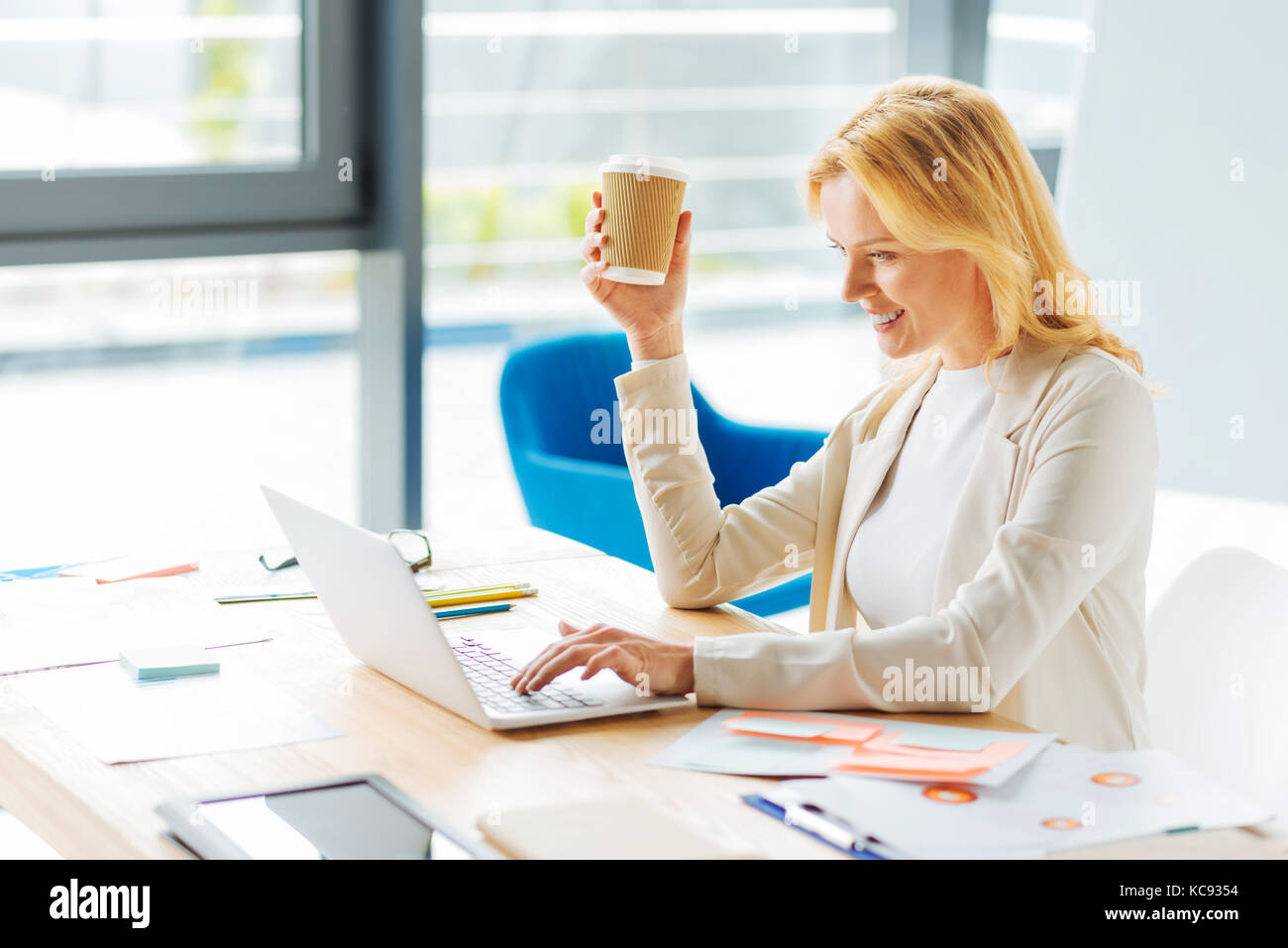 Delighted blonde checking her email Stock Photo - Alamy
