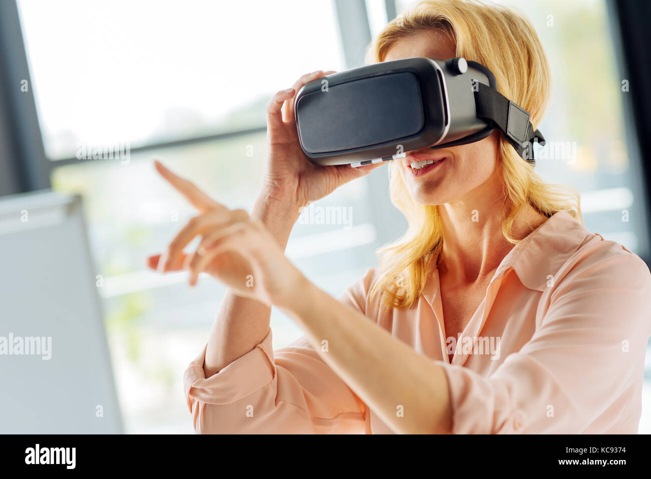 Positive delighted woman wearing special mask Stock Photo - Alamy