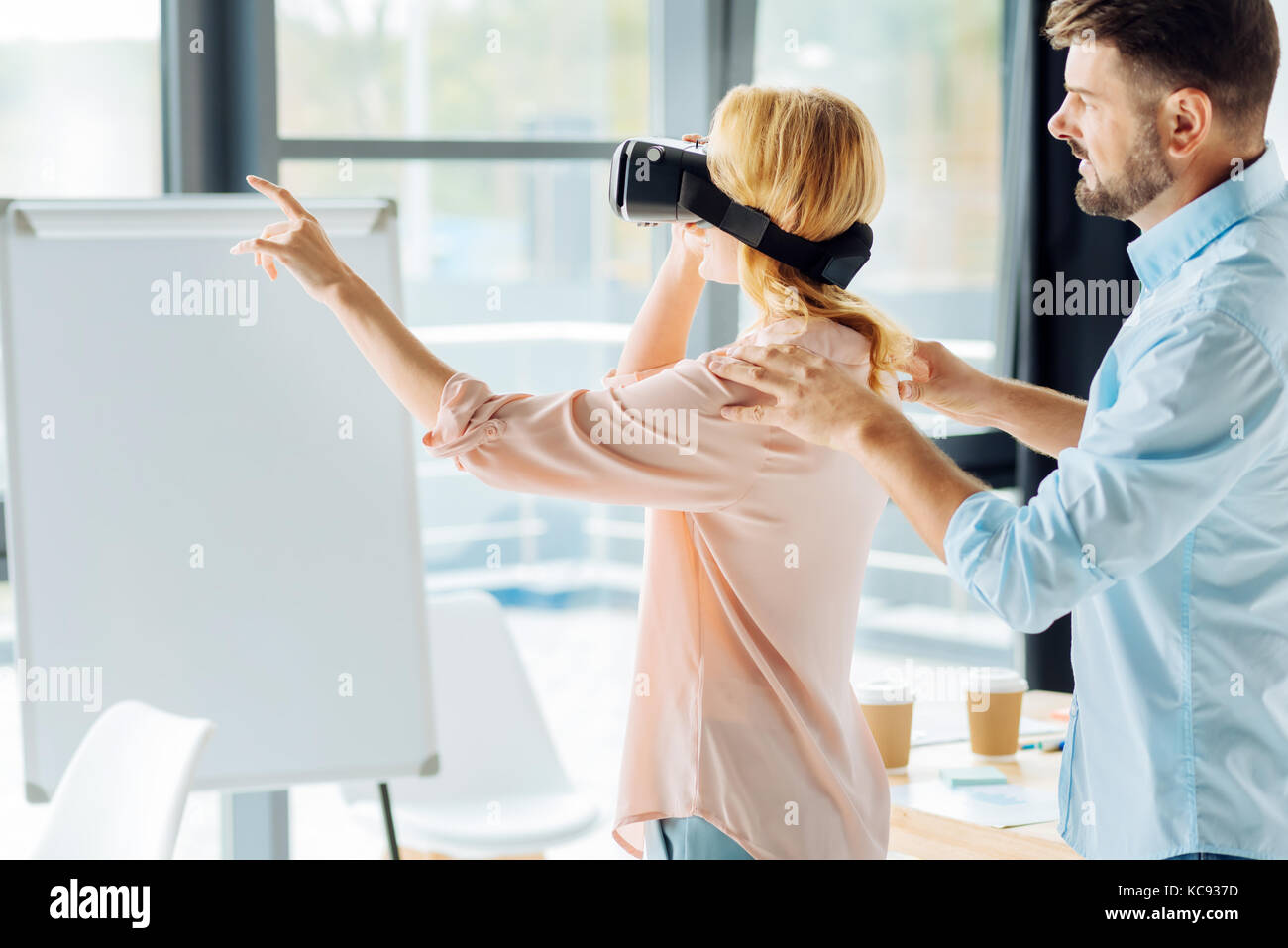 Helping his colleague hi-res stock photography and images - Alamy
