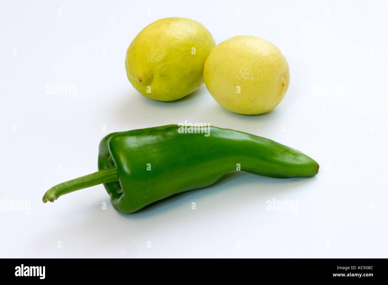 Lemons and pepper on white background Stock Photo - Alamy