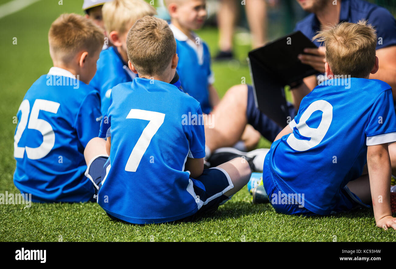 Coach is giving kids soccer team pre game talk. Children spccer ...