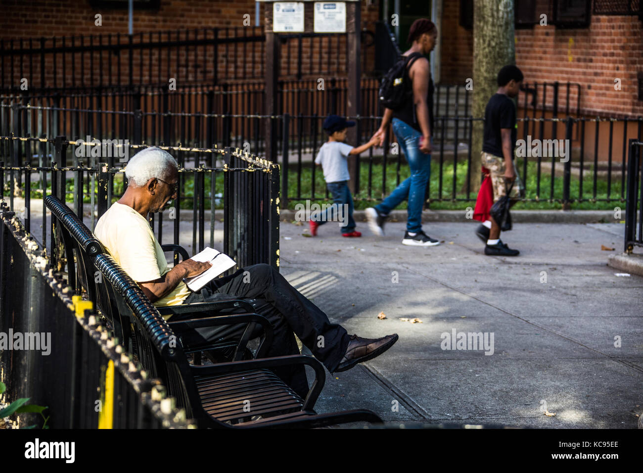 Reading the Bible in low income housing, East Village, New York City ...