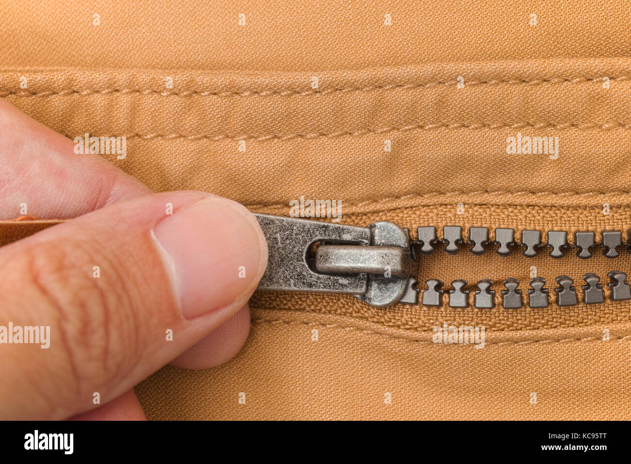 Hand opens a bag with a zipper. Close up Stock Photo - Alamy