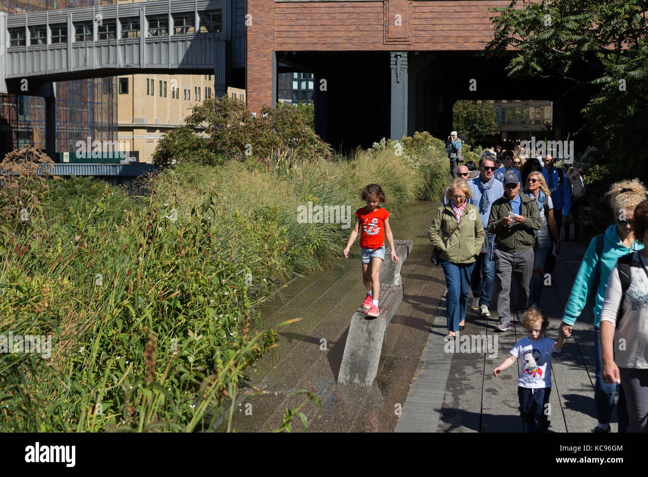 Pedestrians walk along the High Line in New York, New York on October ...