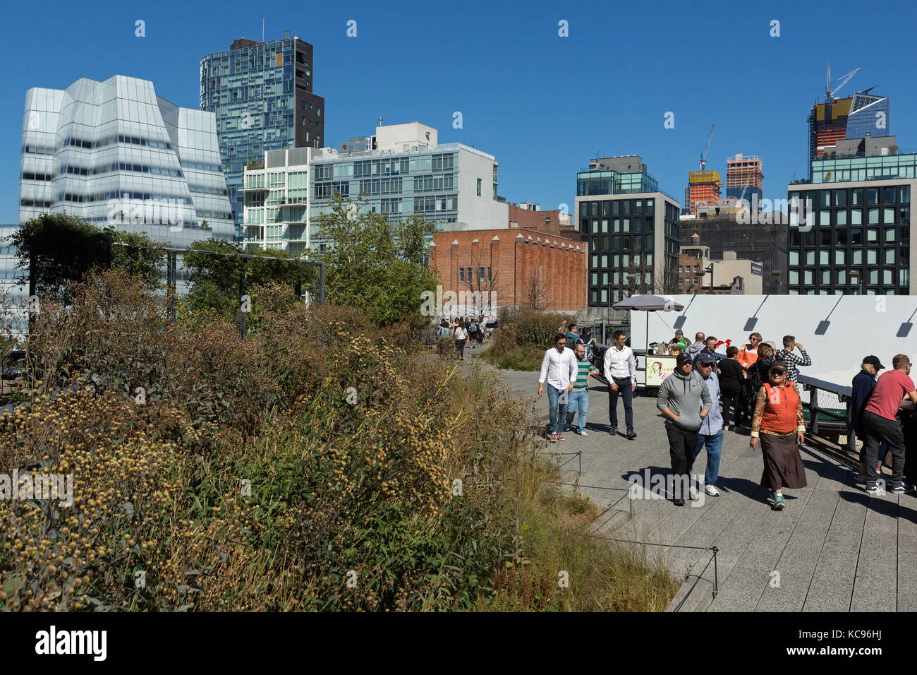 Pedestrians walk along the High Line in New York, New York on October ...
