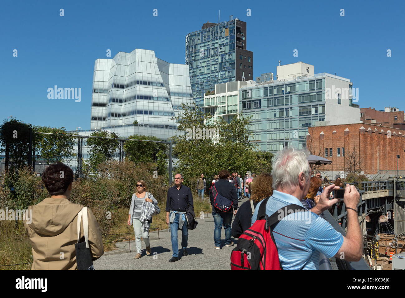 Pedestrians walk along the High Line in New York, New York on October ...