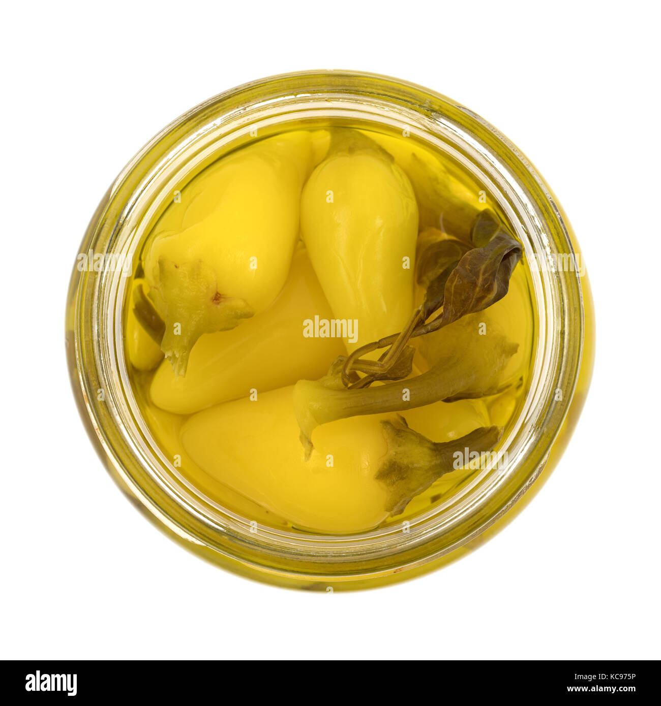 Top view of an opened glass jar filled with hot yellow canned chili ...