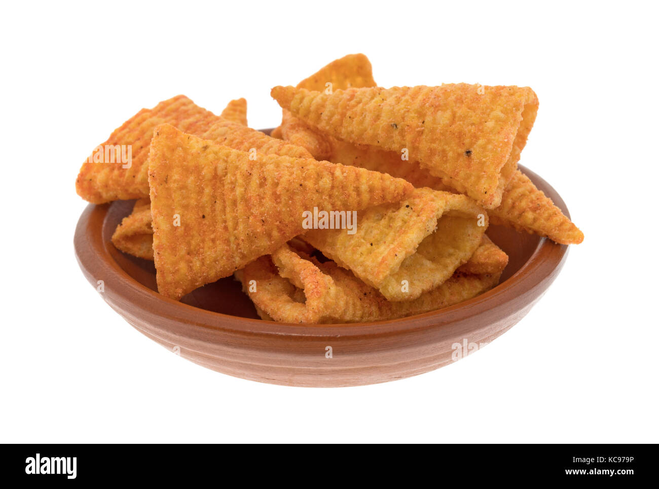A small red clay bowl filled with cheese flavored cone shaped corn ...
