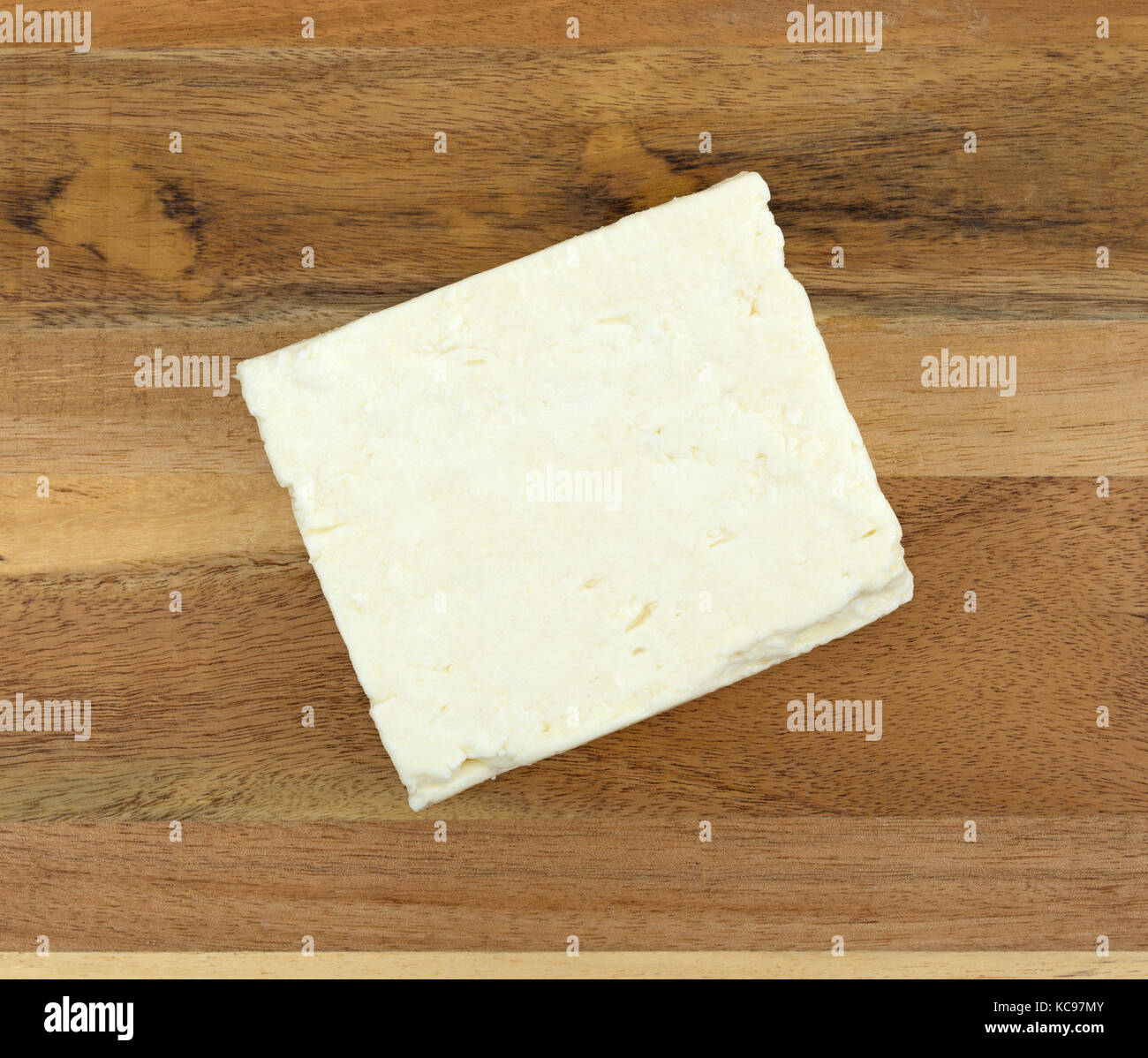 Top view of a block of feta cheese on a wood cheese board Stock Photo ...