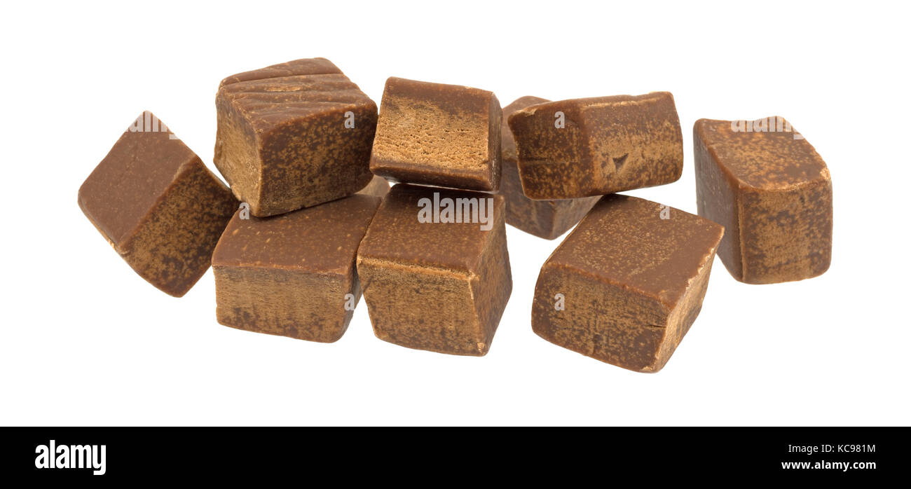 Several chunks of butter chocolate fudge isolated on a white background ...