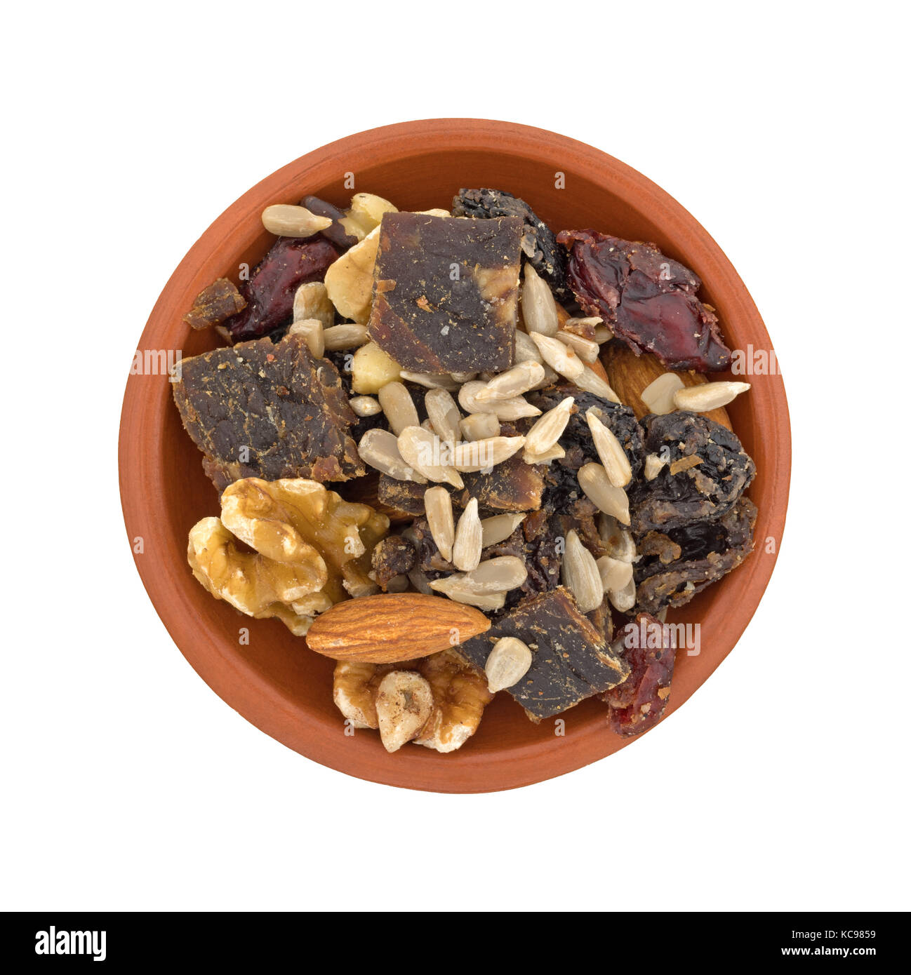 Top view of a serving of beef jerky trail mix in a small red clay bowl ...