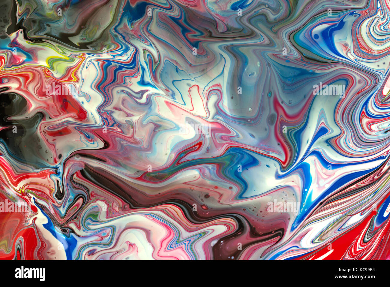 A close view of wet colorful poster paint brushed into an abstract ...