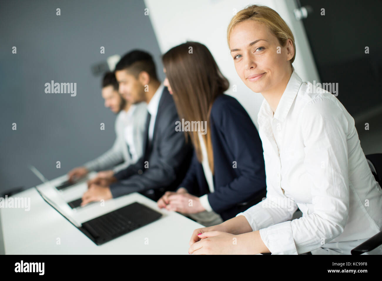 Business team working together in modern office to achieve better ...