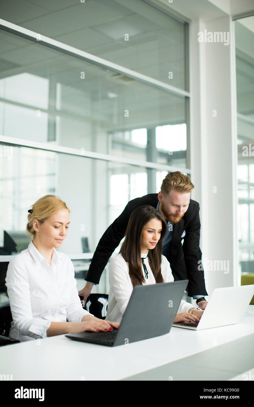 Business team working together in modern office to achieve better ...