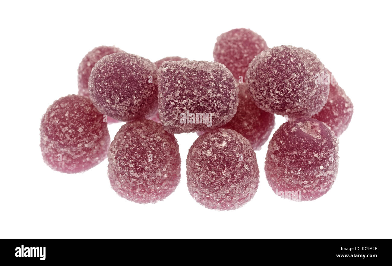 A small pile of purple grape flavored sugar coated sour drop candy ...