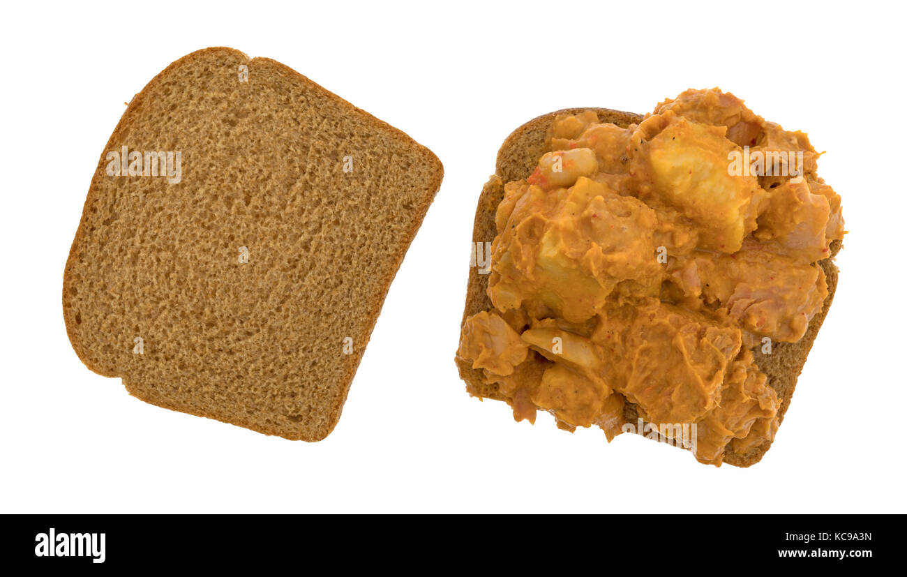 Top view of a red curry flavored tuna fish opened face wheat bread ...