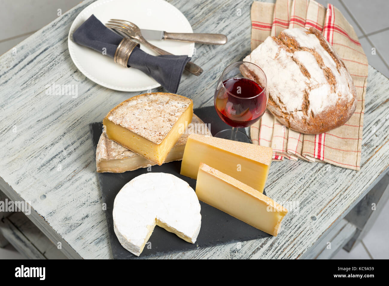 Different french cheeses with a glass of red wine Stock Photo - Alamy