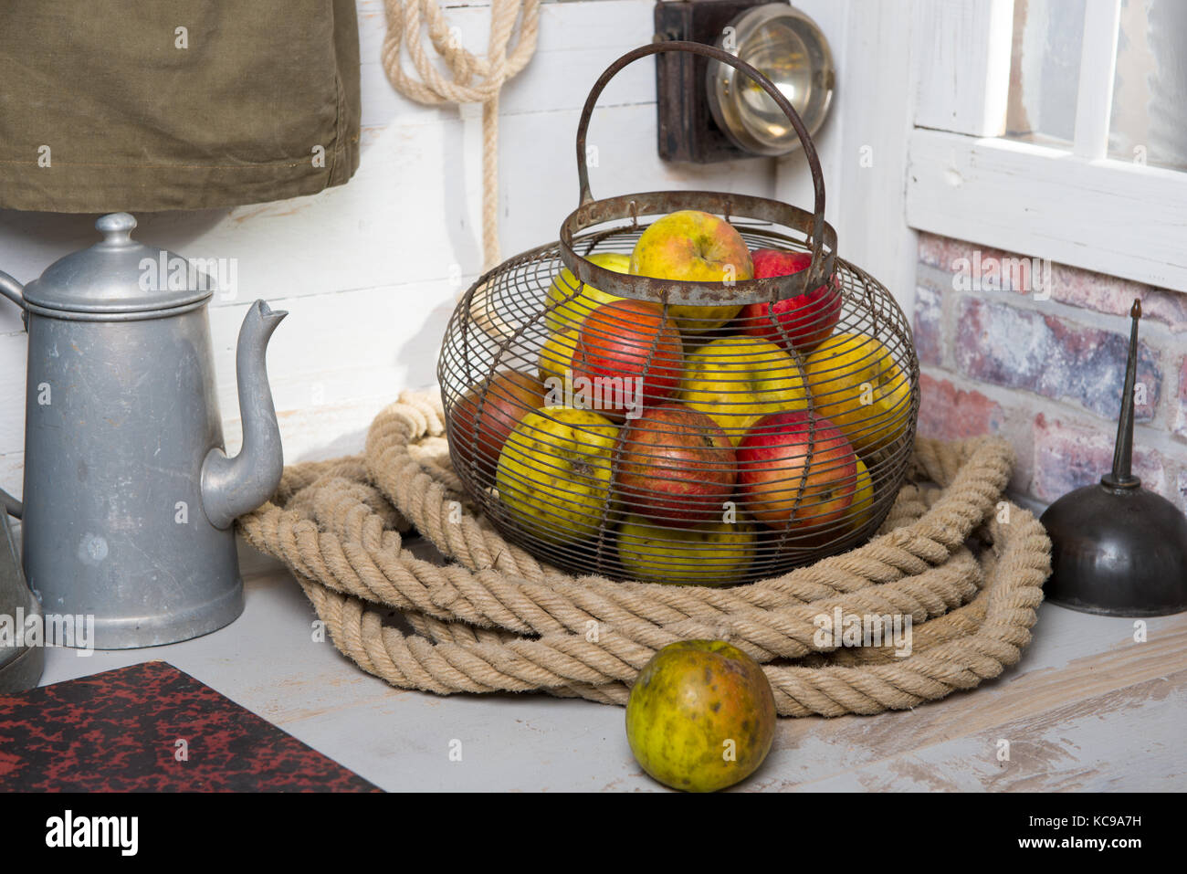 a basket in metal with organic apples on a rope Stock Photo - Alamy