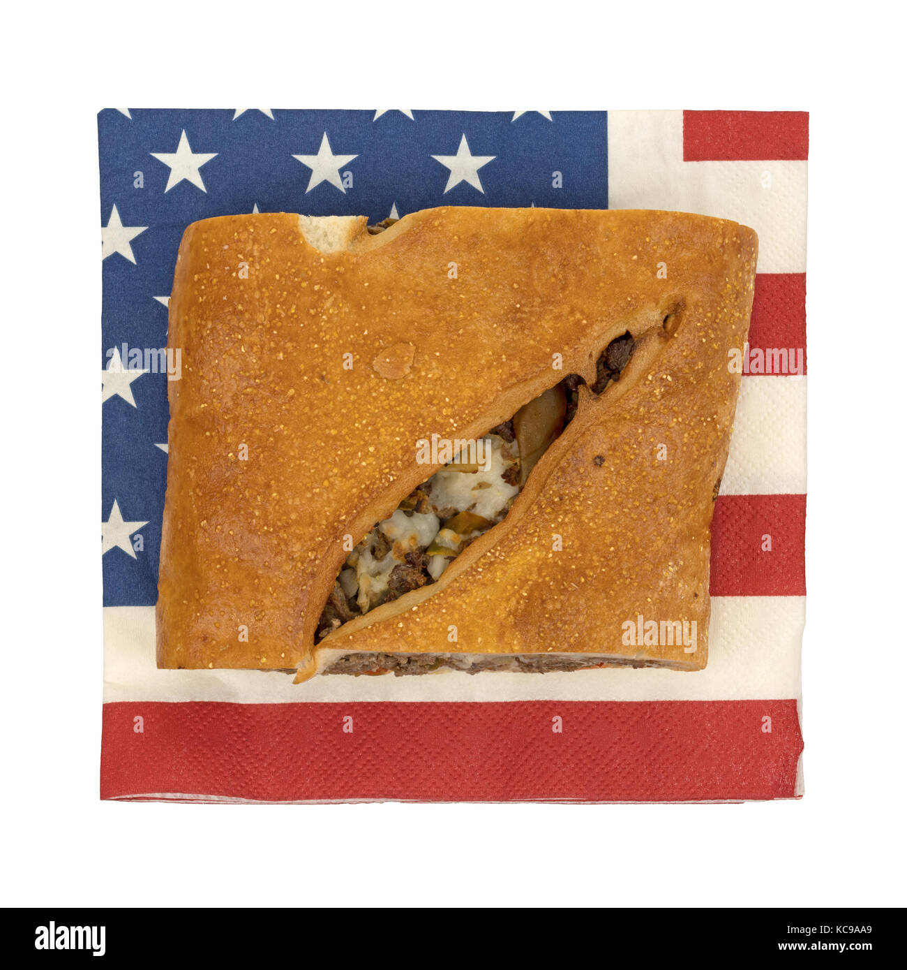 Top view of a slice of baked steak stromboli on an American motif ...
