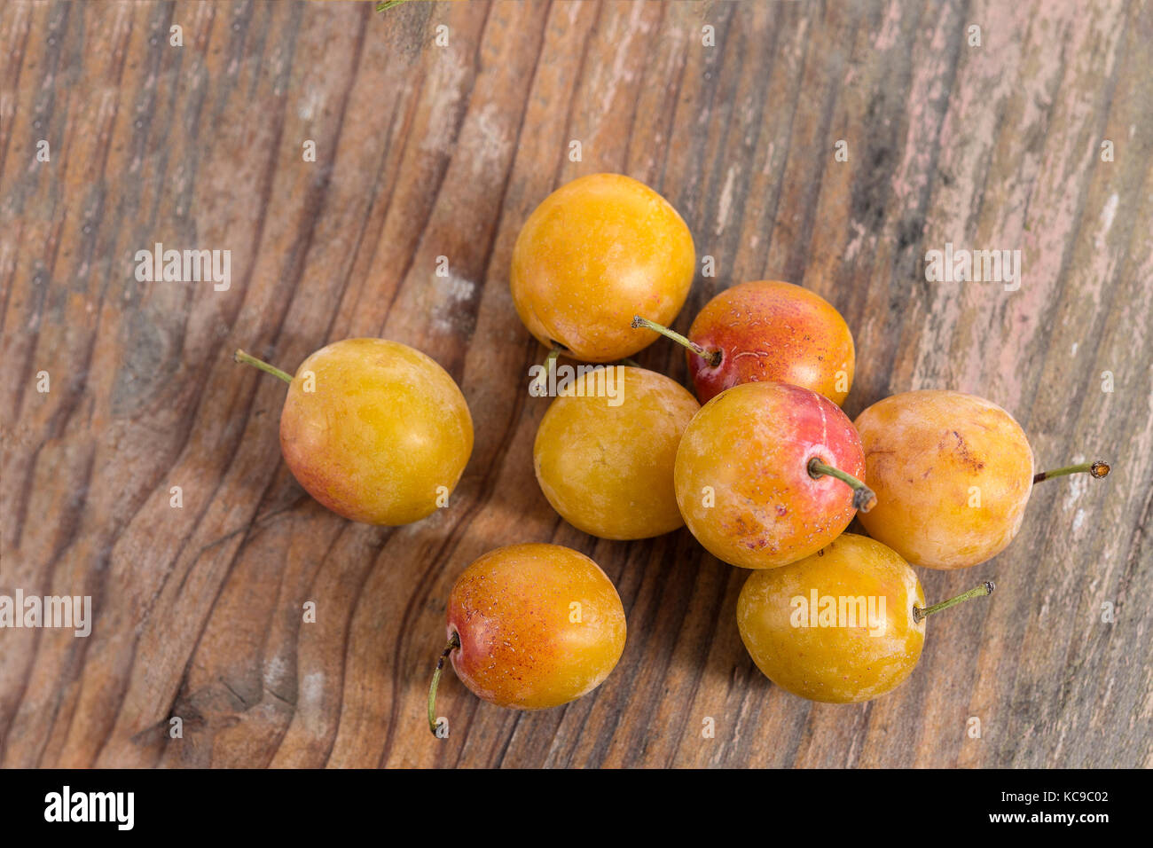 Fresh harvested yellow mirabelle plums on wooden floor top view Stock ...