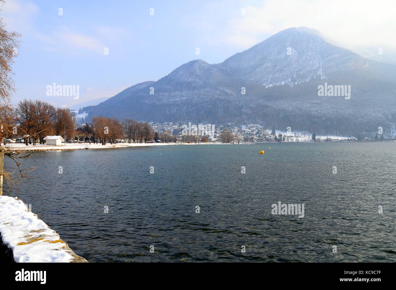 Annecy lake, beach of Albigny, under snow, winter landscape in Savoy ...