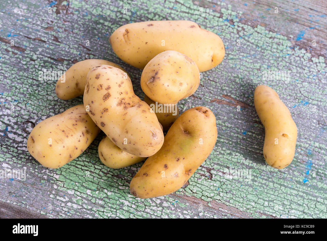 French new potato tuber isolated on blue wooden background cutout Stock ...