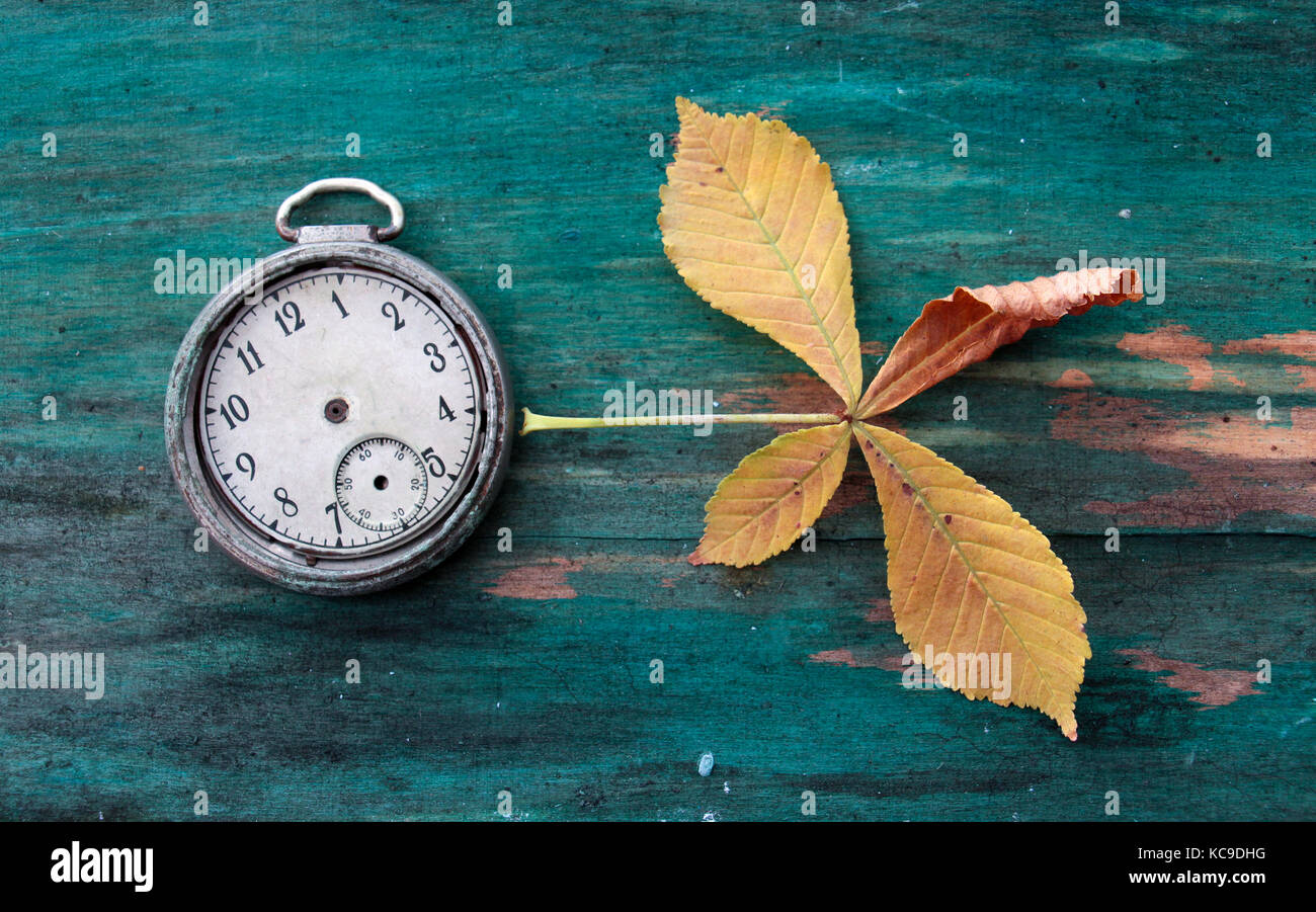 vintage clock and autumn leaf on wood background,image of a Stock Photo ...