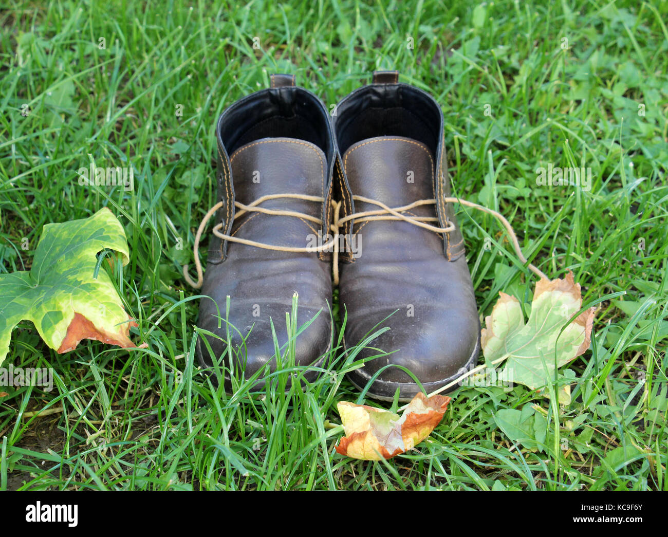 Warm men's leather boots on a grass background,image of a Stock Photo ...