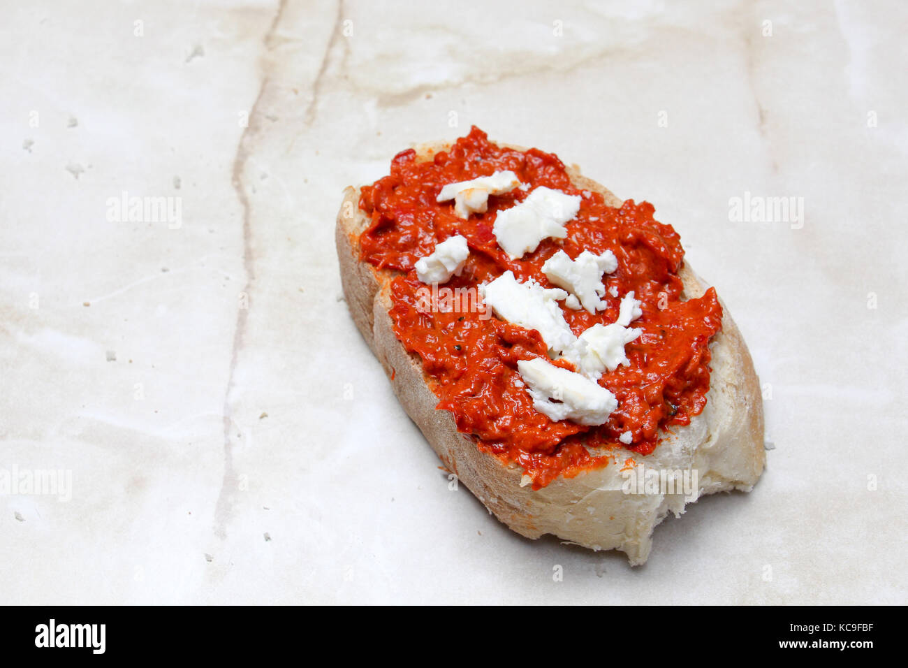 Pieces of a cheese on traditional macedonian food ayvar smeared on a ...