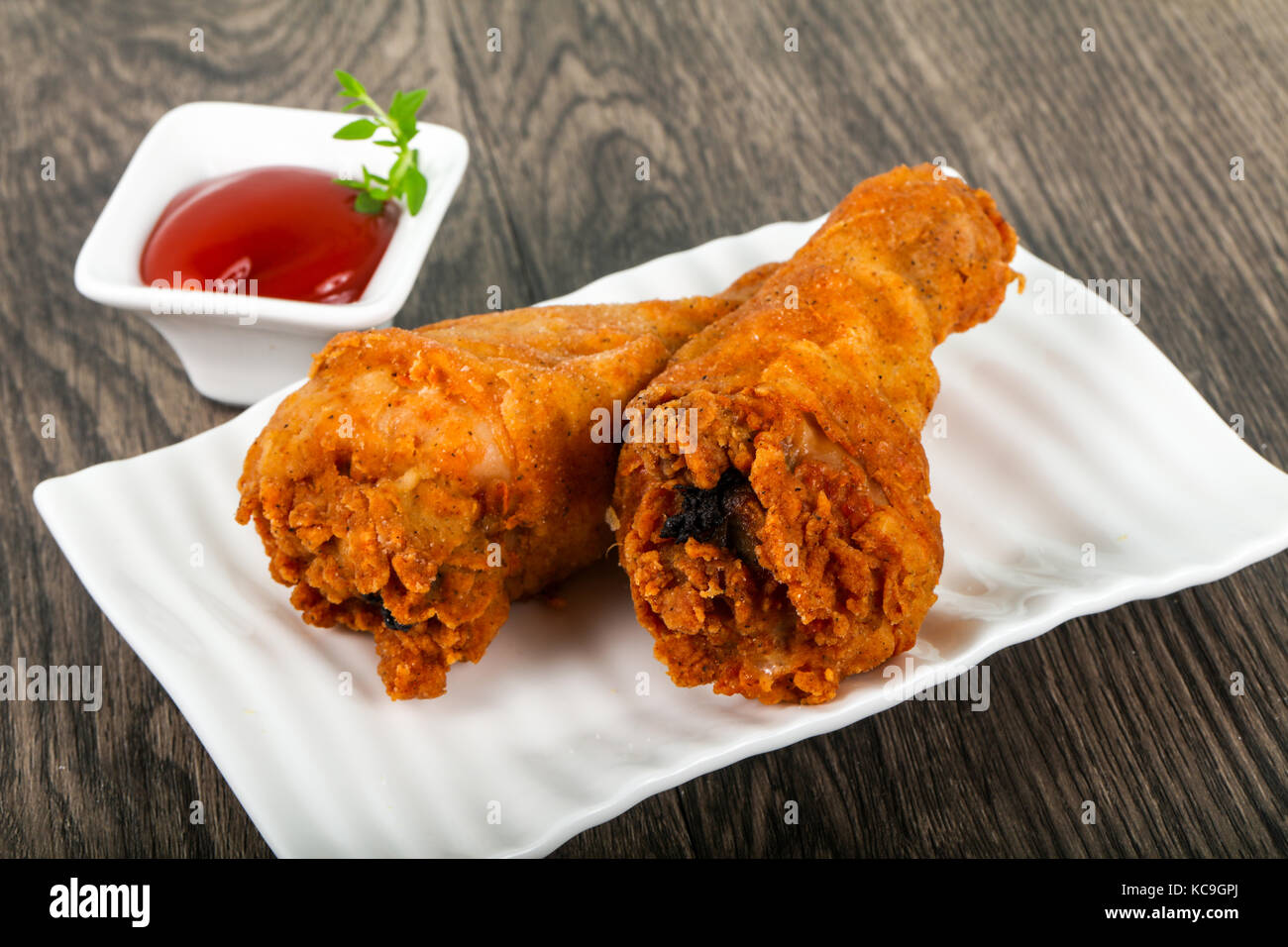 Crispy chicken legs with ketchup Stock Photo - Alamy
