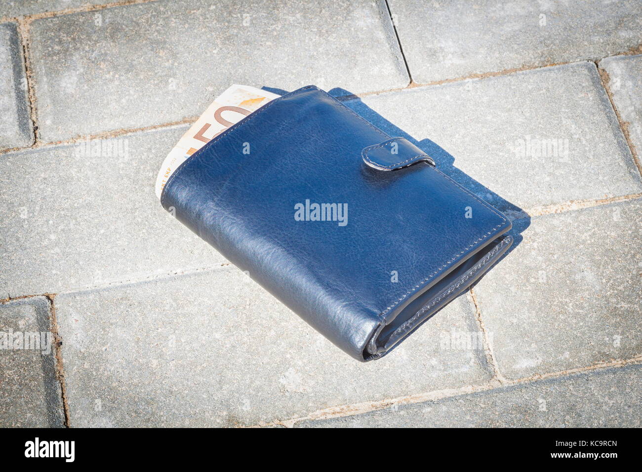 Wallet on the path Stock Photo - Alamy
