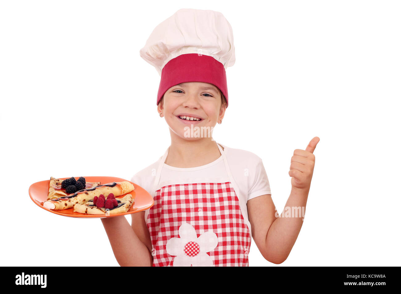 happy little girl cook with crepes and thumb up Stock Photo - Alamy