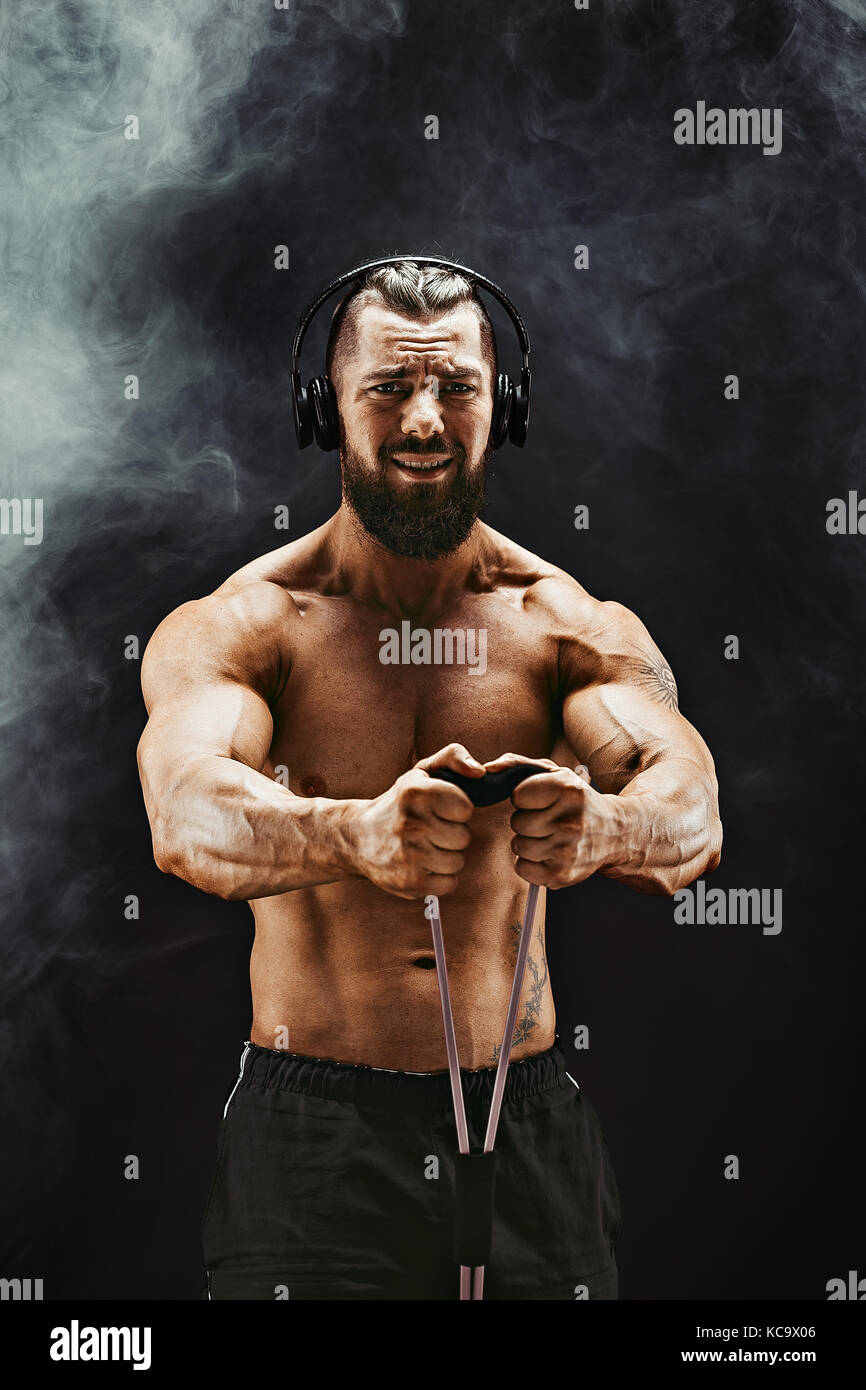 Fitness man exercising with stretching band. Muscular sports man ...