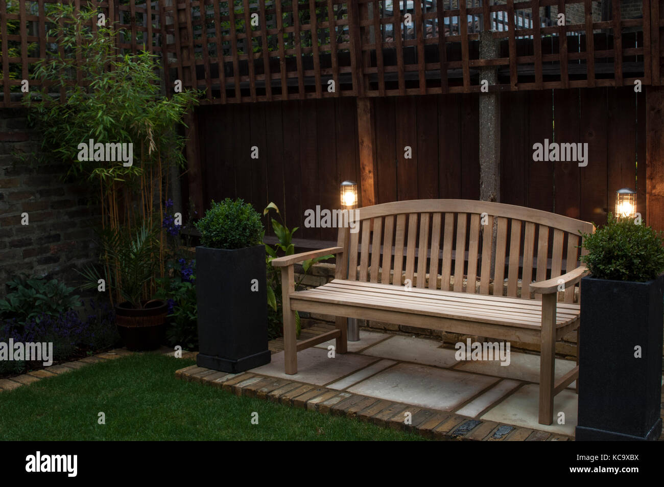 Bench in a garden, evening Stock Photo - Alamy