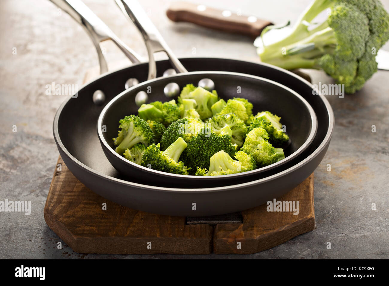 Steamed or stewed broccoli in a skillet Stock Photo - Alamy