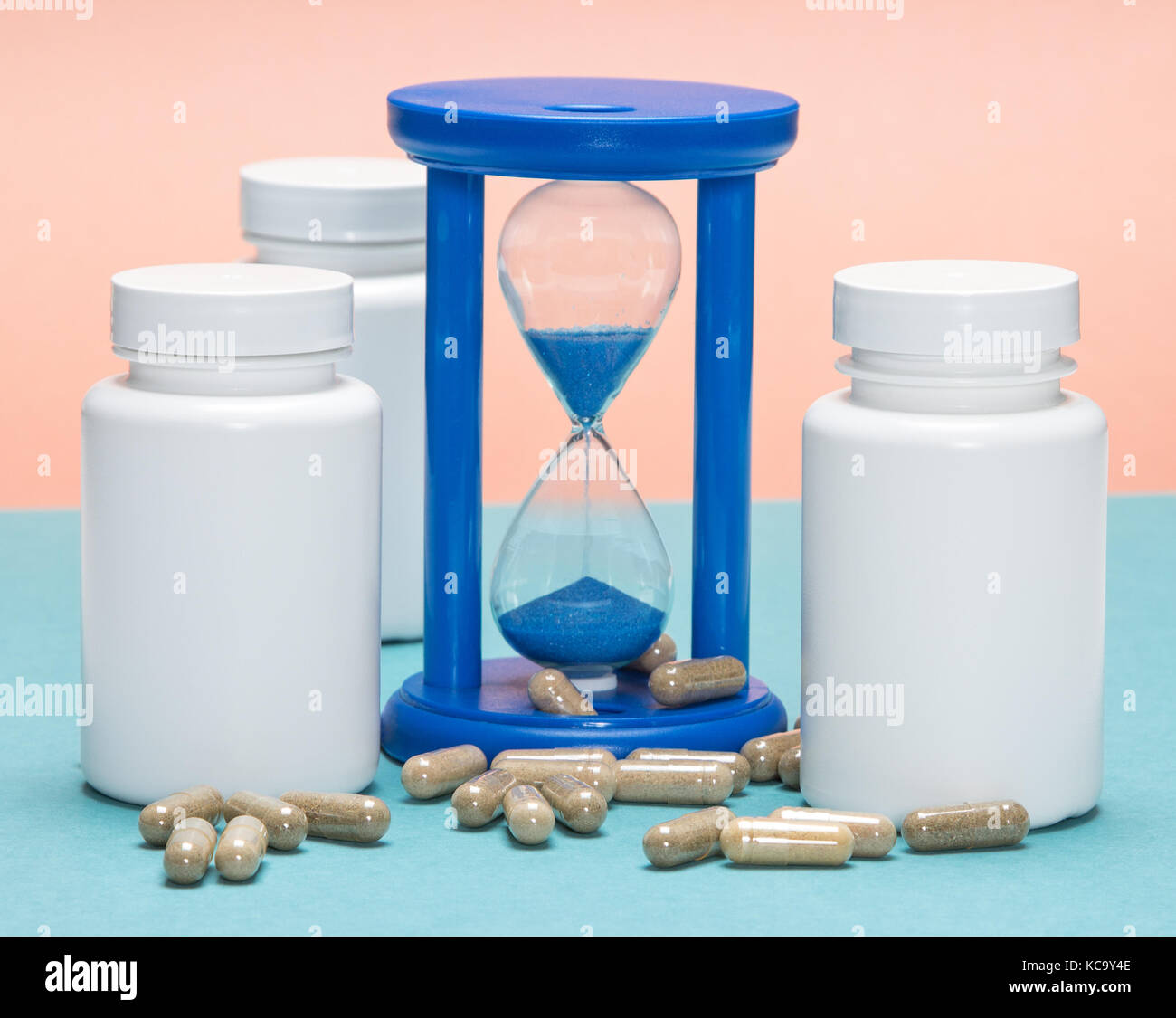 Anti-aging supplements concept: scattered capsules with white plastic ...